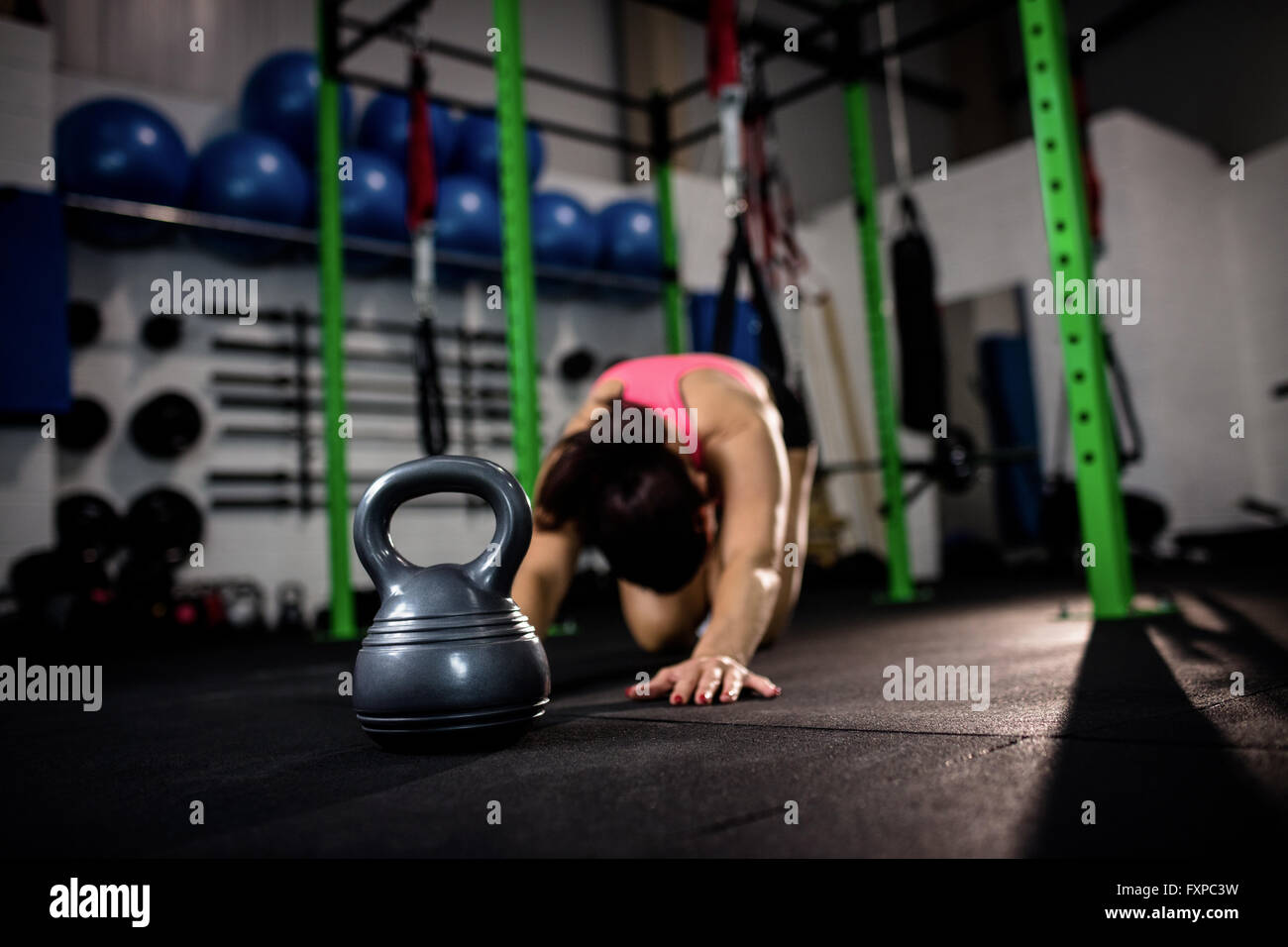 Woman stretching her back after a heavy kettlebell workout Stock Photo ...