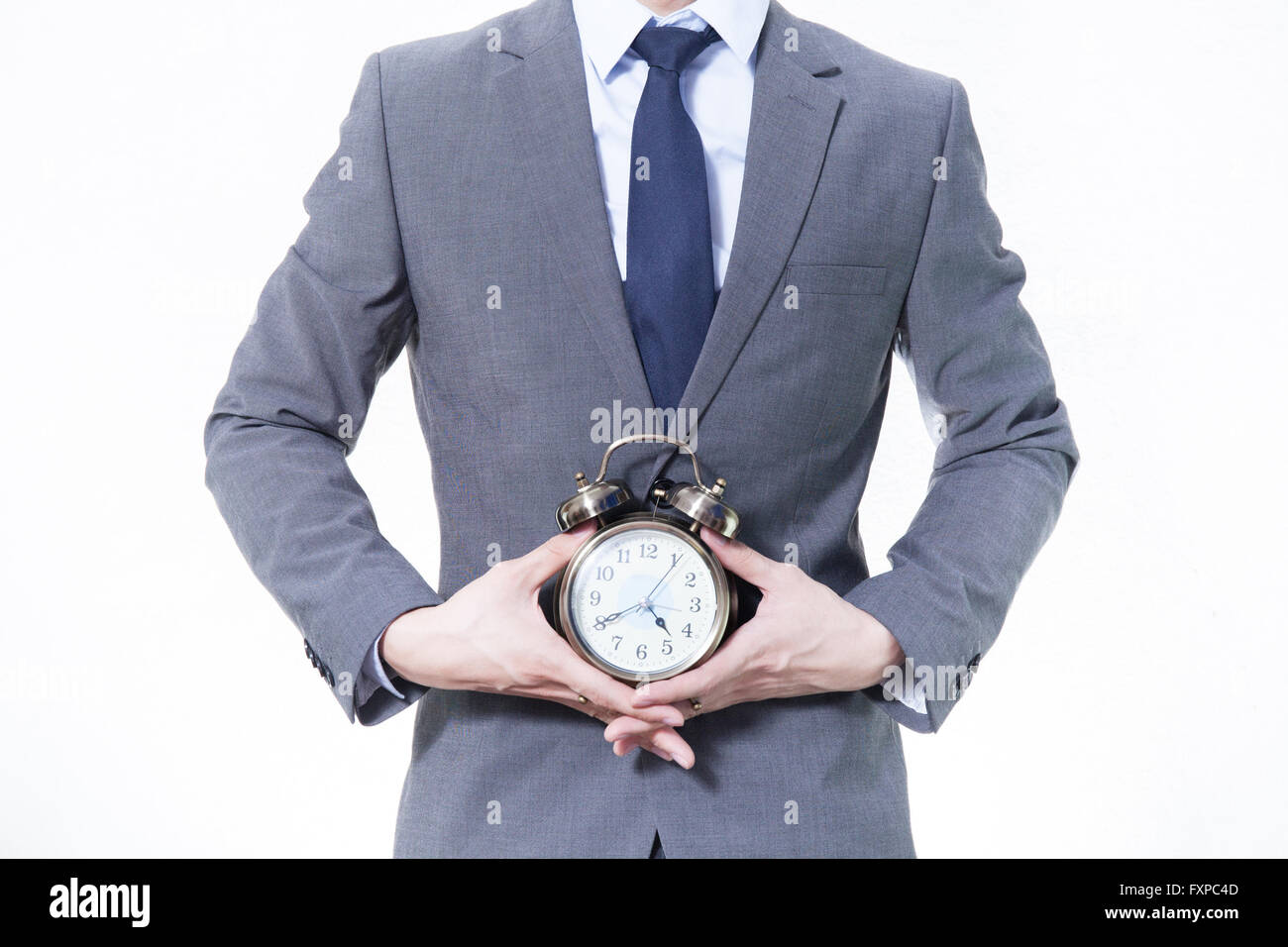 Man in Business Suit holding a clock - on time and business concept ...