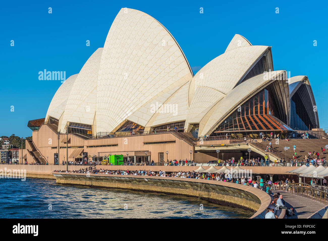 Sydney Opera House at Sydney, Australia. As the sun sets and casts warm ...