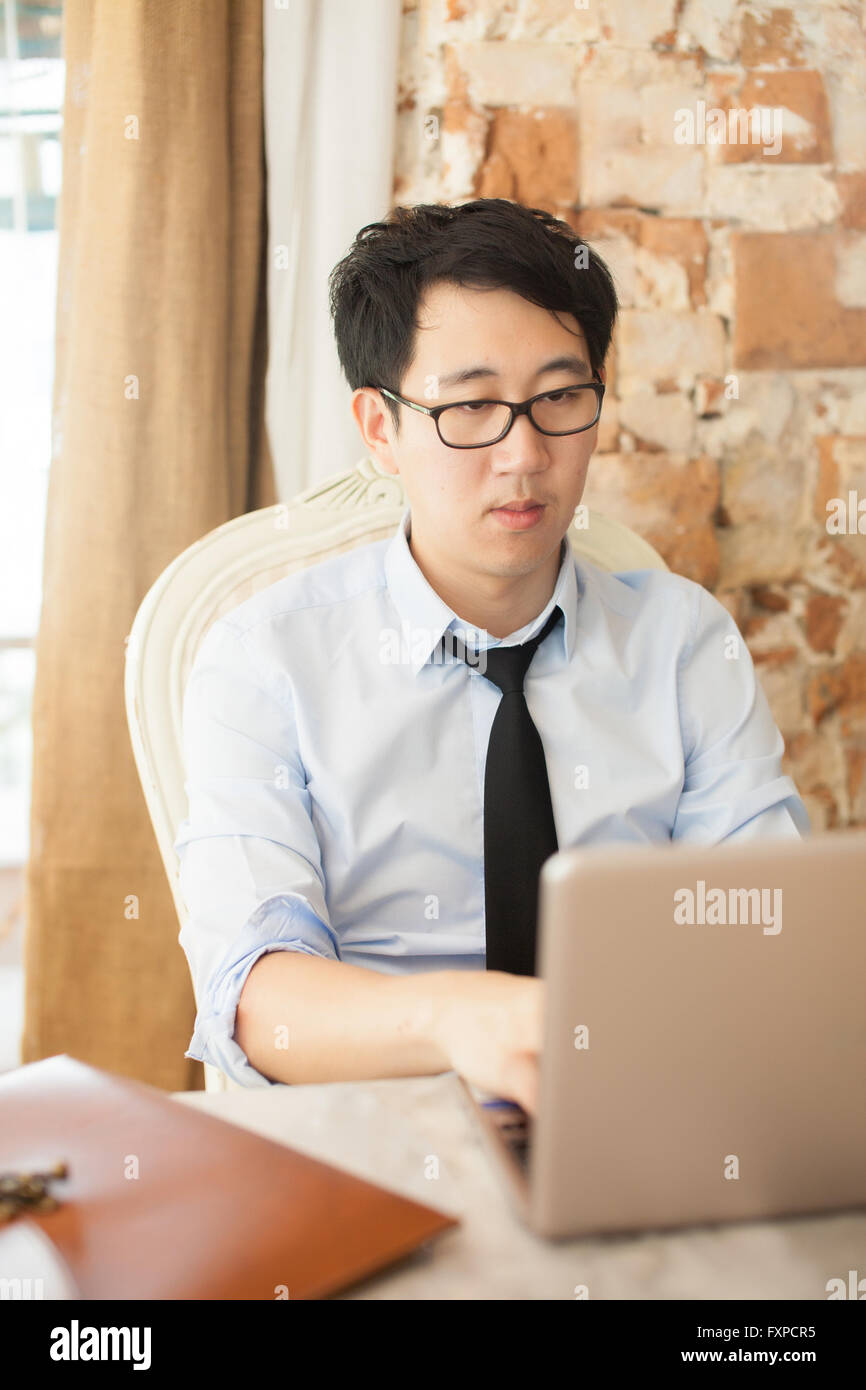 Casual businessman working while looking boring in outdoor office Stock ...