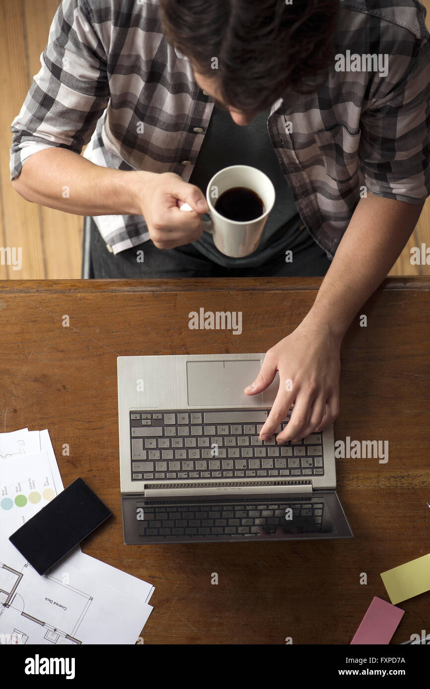 Man at desk using laptop Stock Photo - Alamy