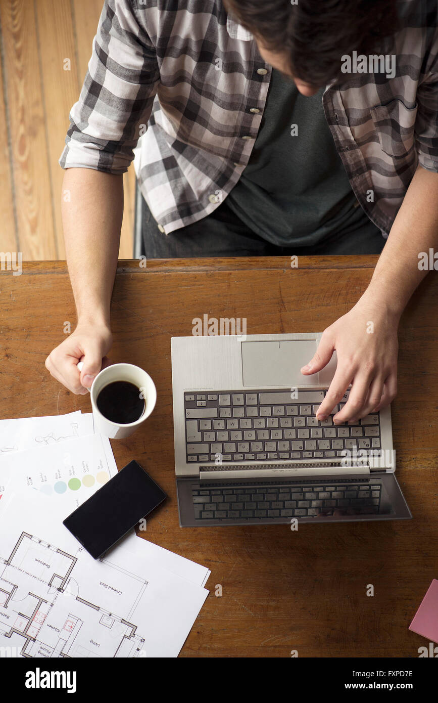 Man working smartphone laptop blueprints hi-res stock photography and ...