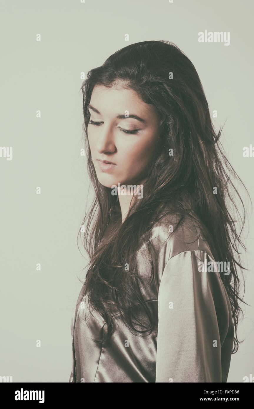 Sad young woman looking away Stock Photo - Alamy