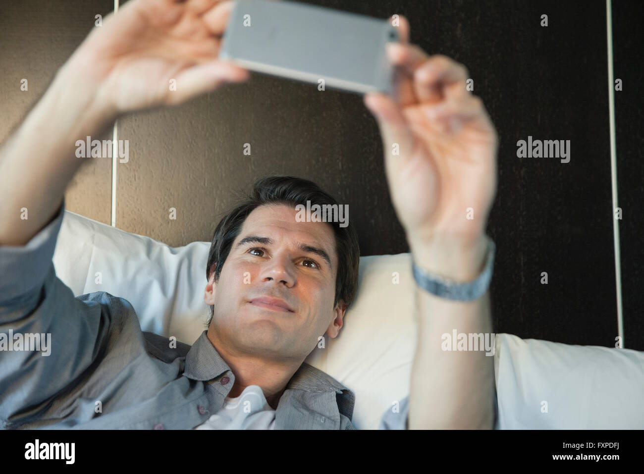 Man using smartphone to take a selfie Stock Photo - Alamy
