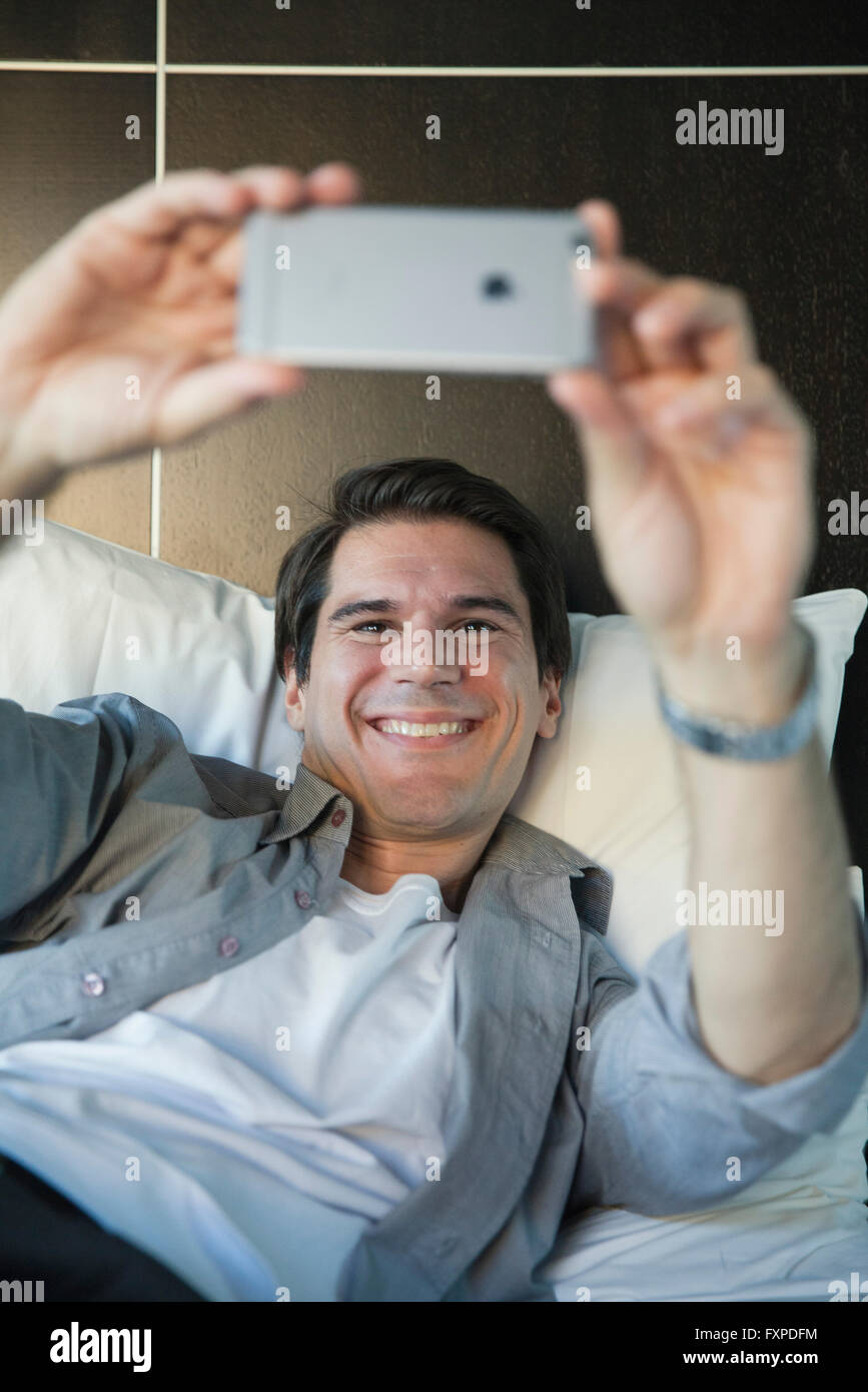 Man using smartphone to take a selfie Stock Photo - Alamy