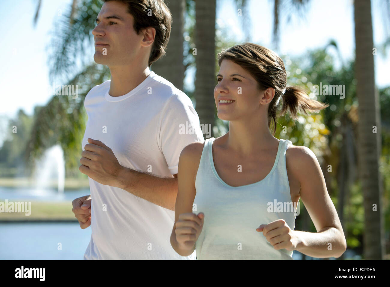 Couple running together Stock Photo - Alamy