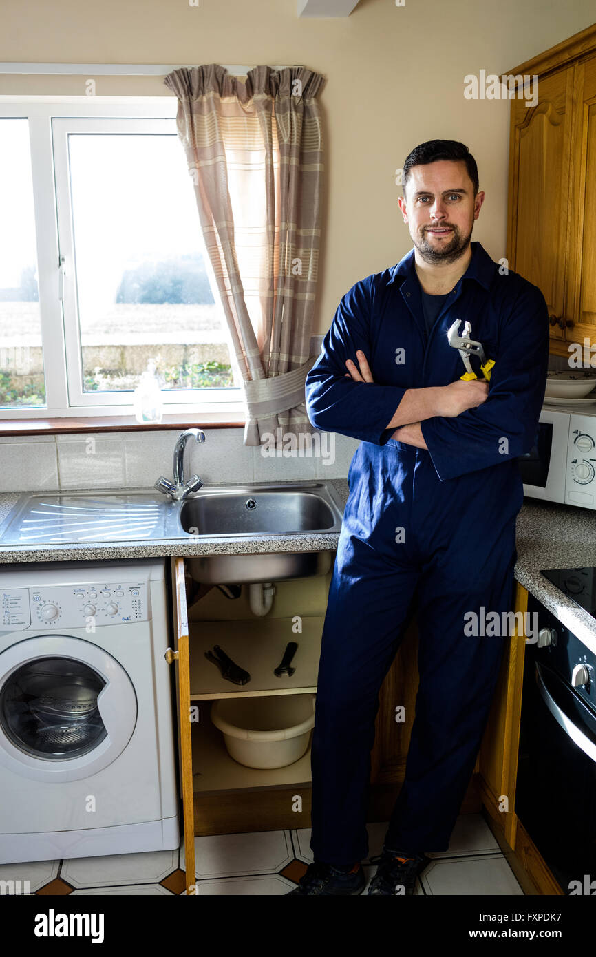 Portrait of plumber standing in kitchen Stock Photo - Alamy
