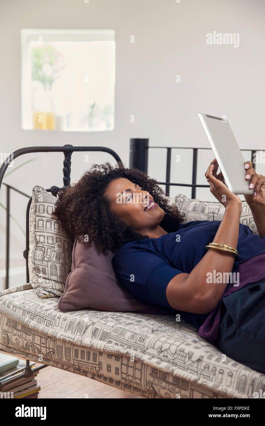 Woman reading ipad on sofa hi-res stock photography and images - Alamy