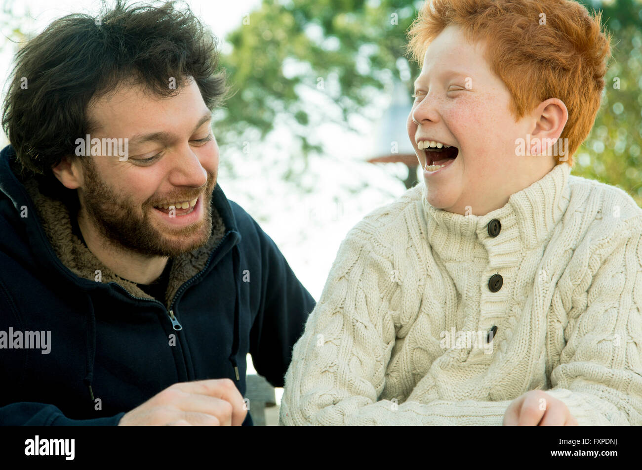 Father and son laughing together outdoors Stock Photo - Alamy