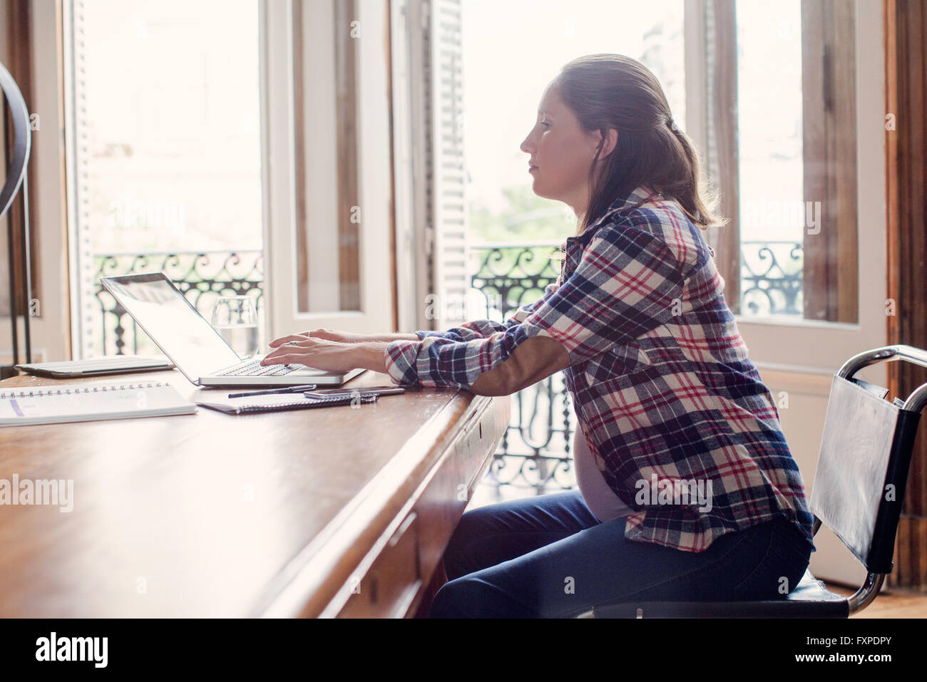 Woman using laptop computer at home Stock Photo - Alamy