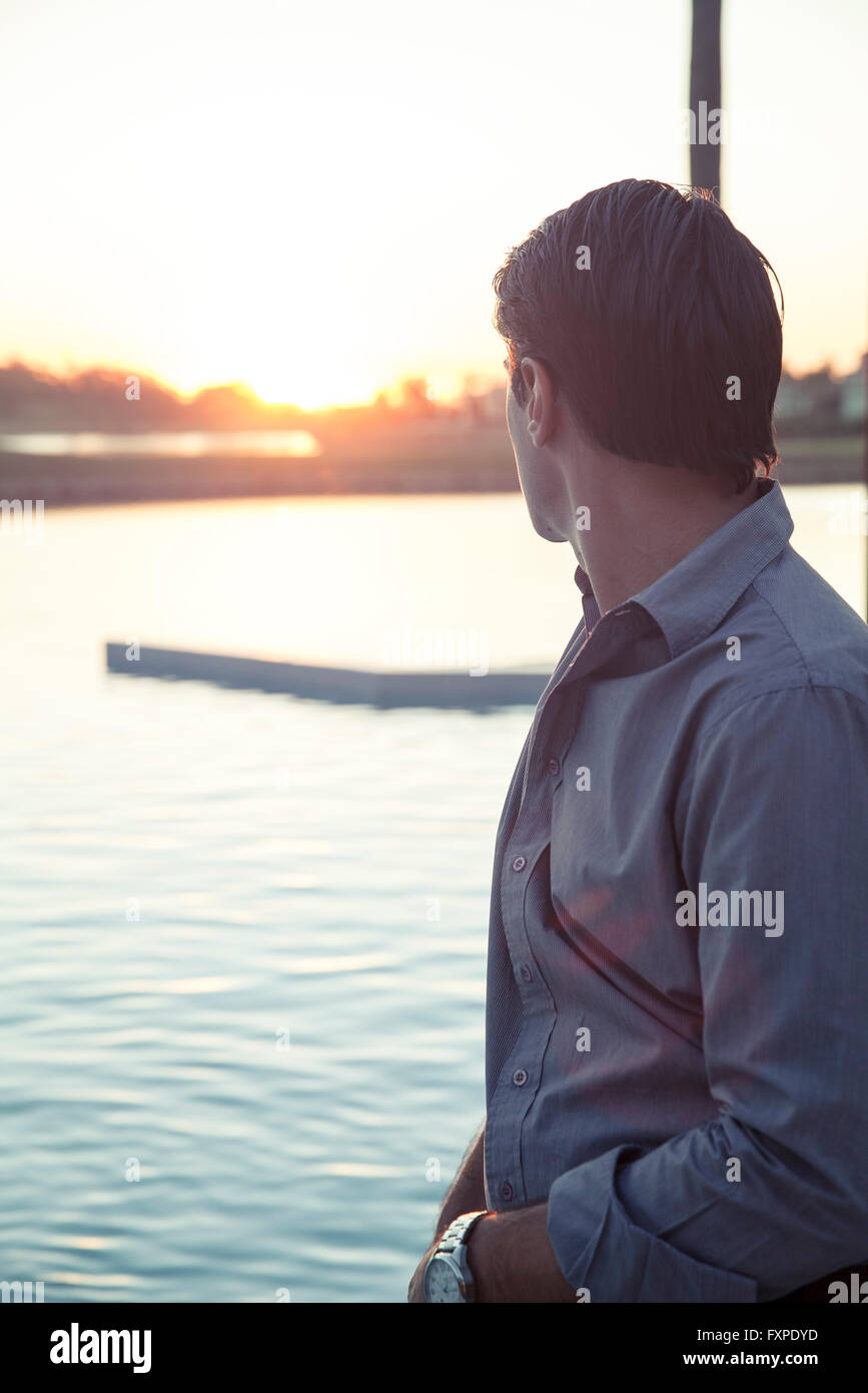 Man looking at sunset Stock Photo - Alamy