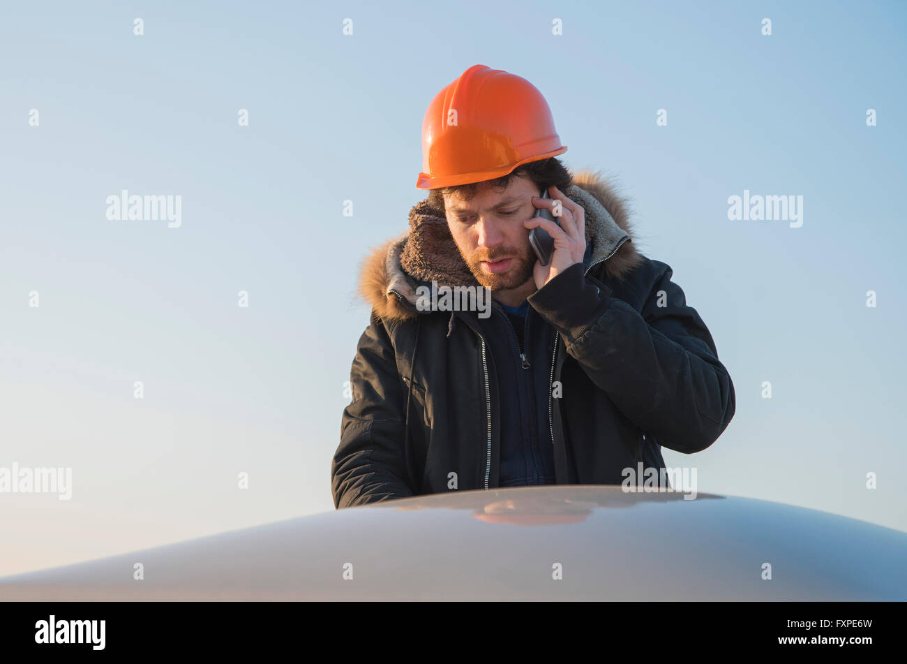 Construction worker talking on cell phone Stock Photo - Alamy