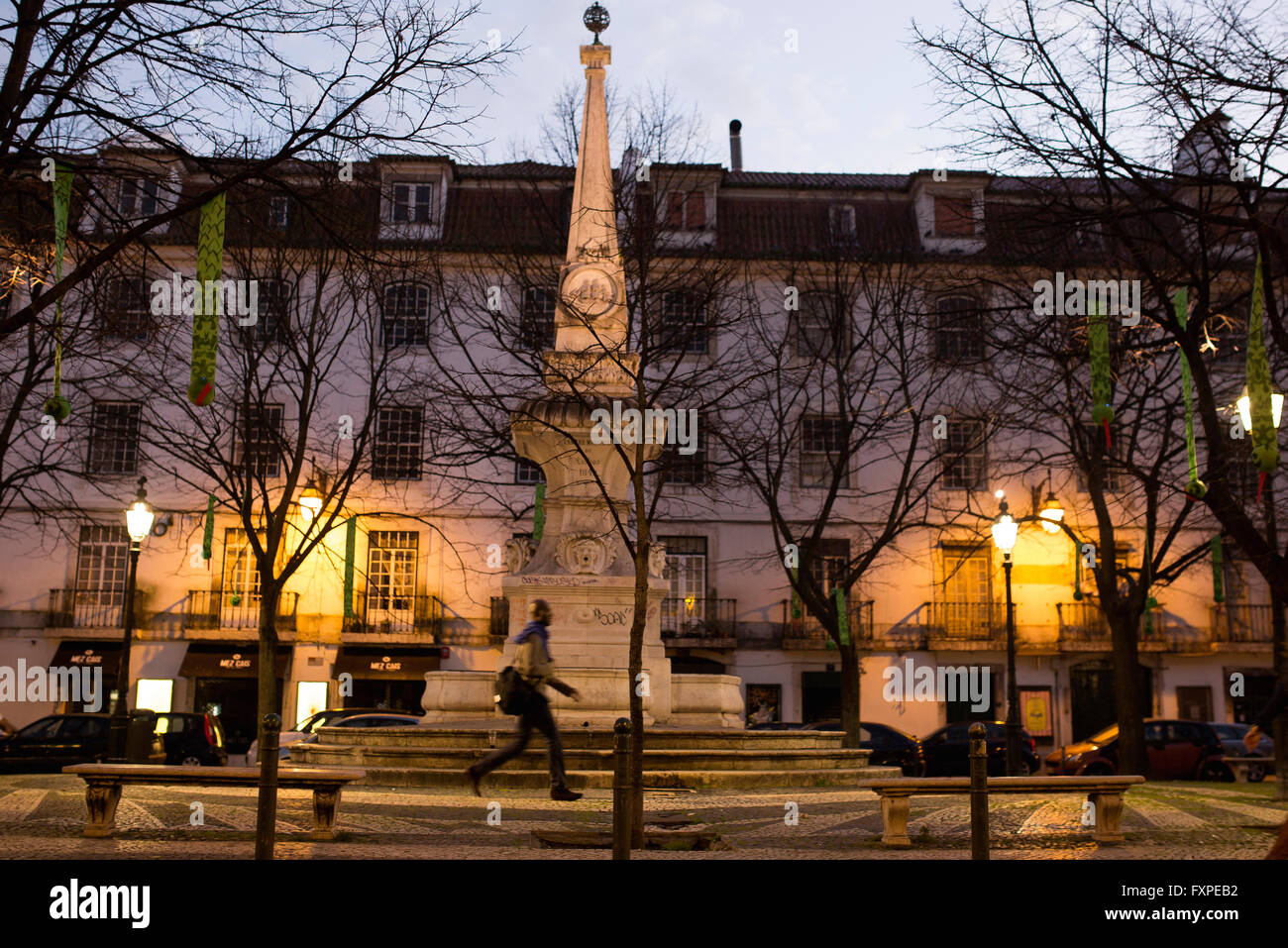 Man walking by statue in park Stock Photo - Alamy