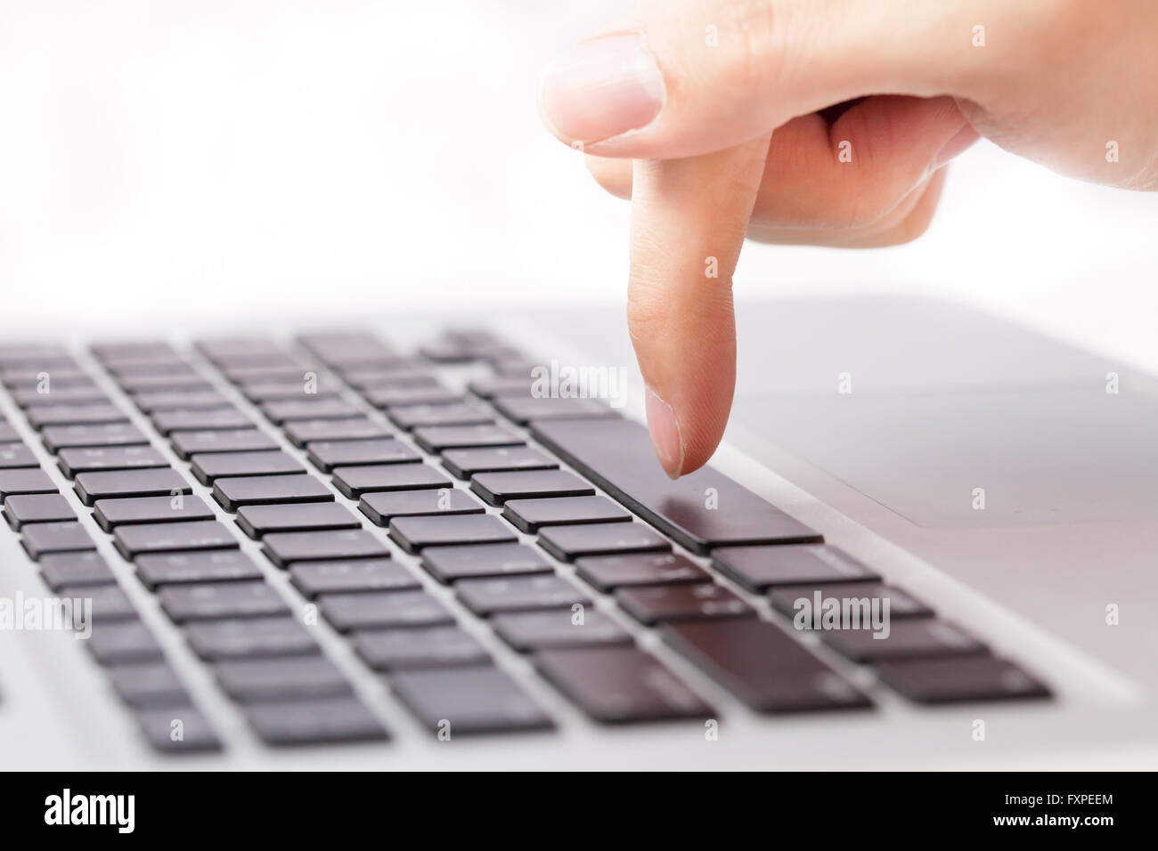 Human hands going to press a button on keypad in white isolated ...