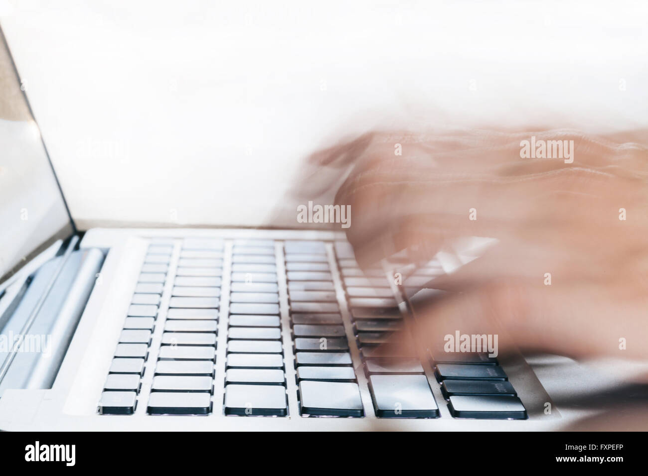 Close-up of Human Hands typing on laptop in blurred motion with copy ...