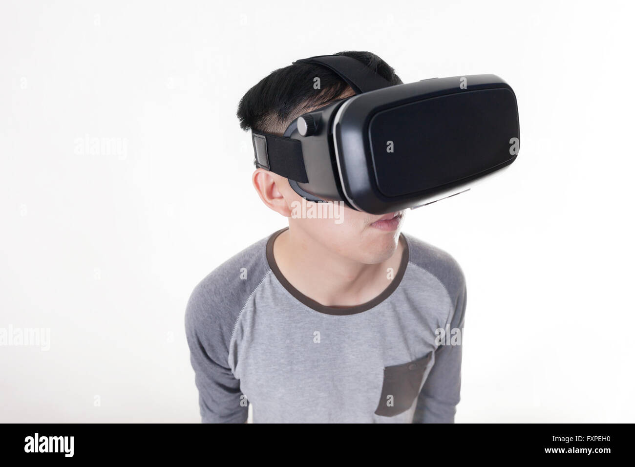 Asian man wearing VR goggle and immersing himself in VR multimedia in ...