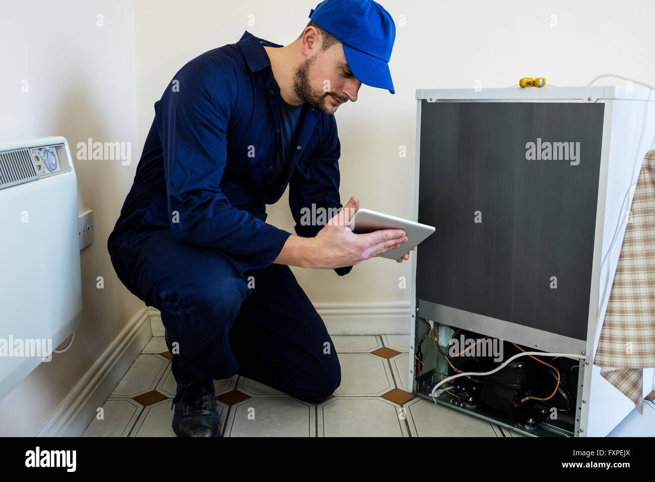 Handyman repairing a machine Stock Photo - Alamy