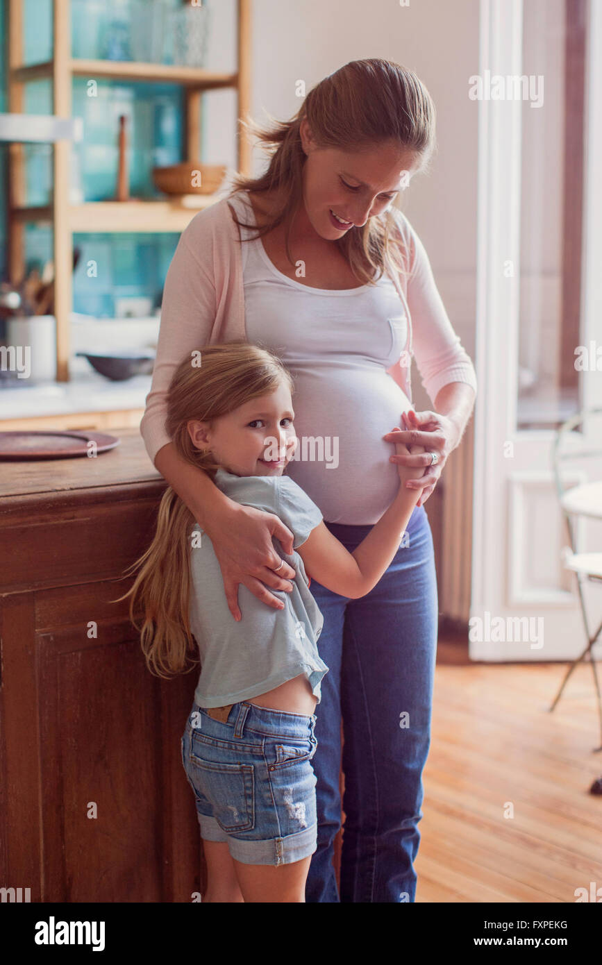 Girls hugging pregnant mothers belly hi-res stock photography and ...