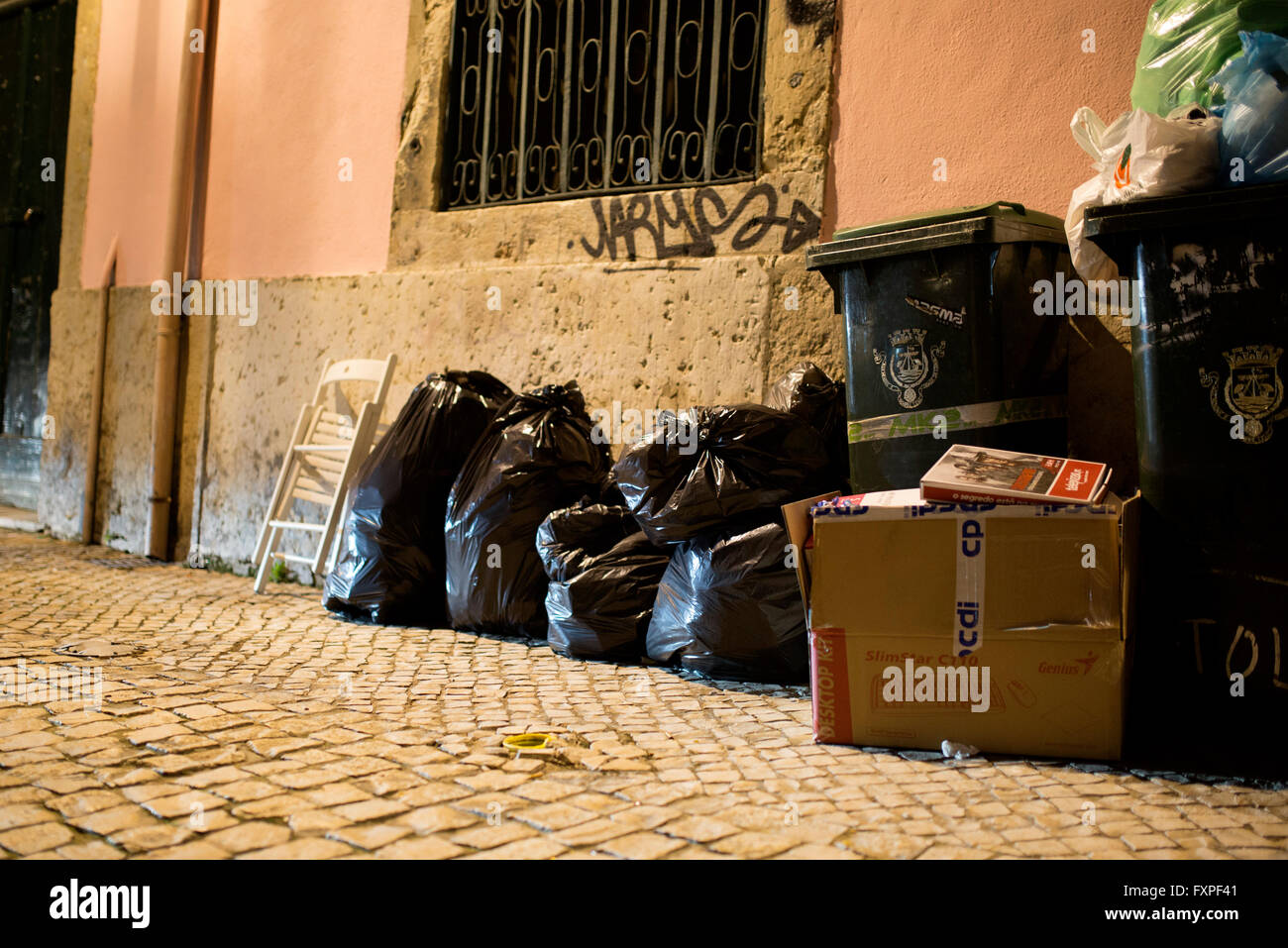 Garbage at side of building Stock Photo - Alamy
