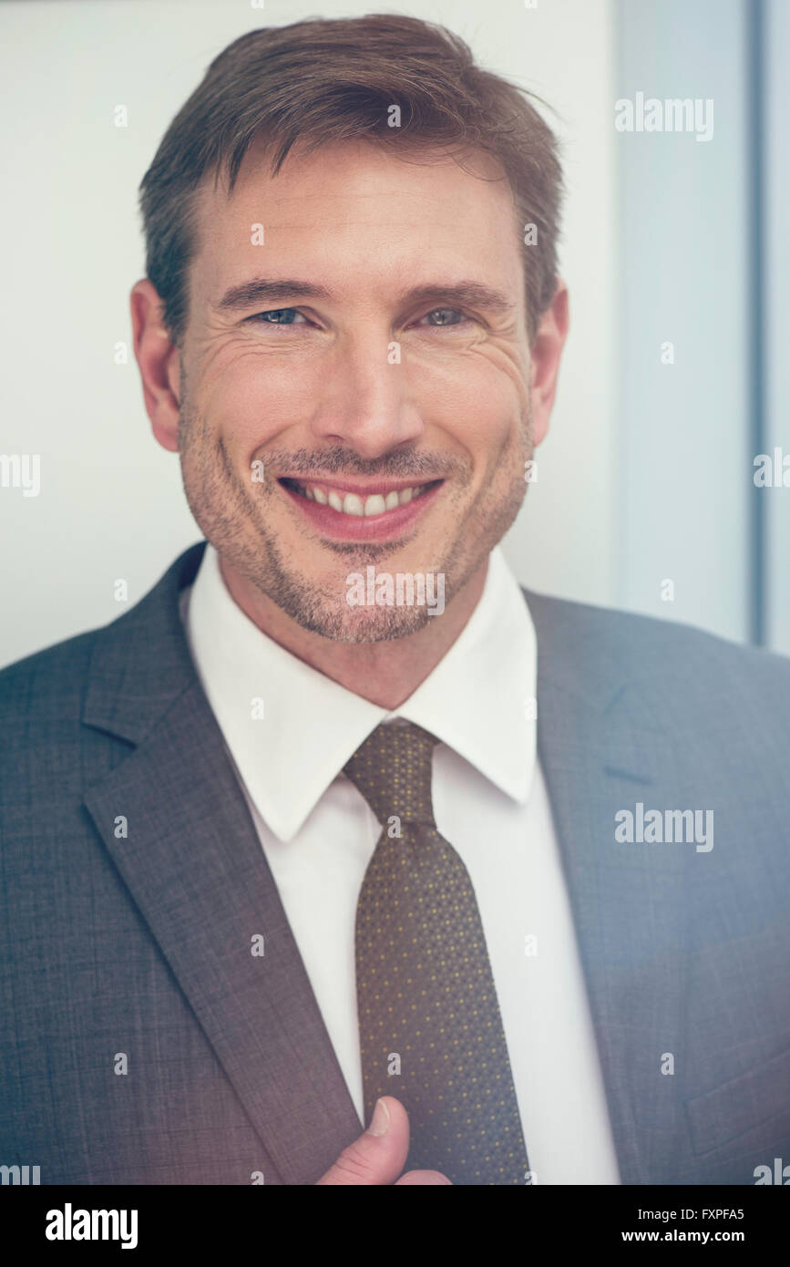 Well dressed businessman smiles hi-res stock photography and images - Alamy