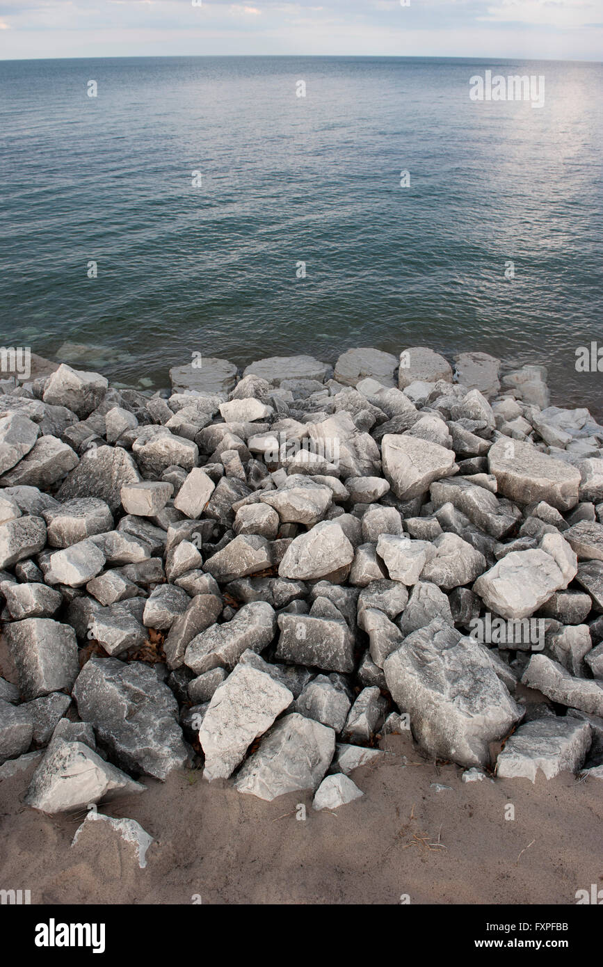 Rocks piled along shore Stock Photo - Alamy