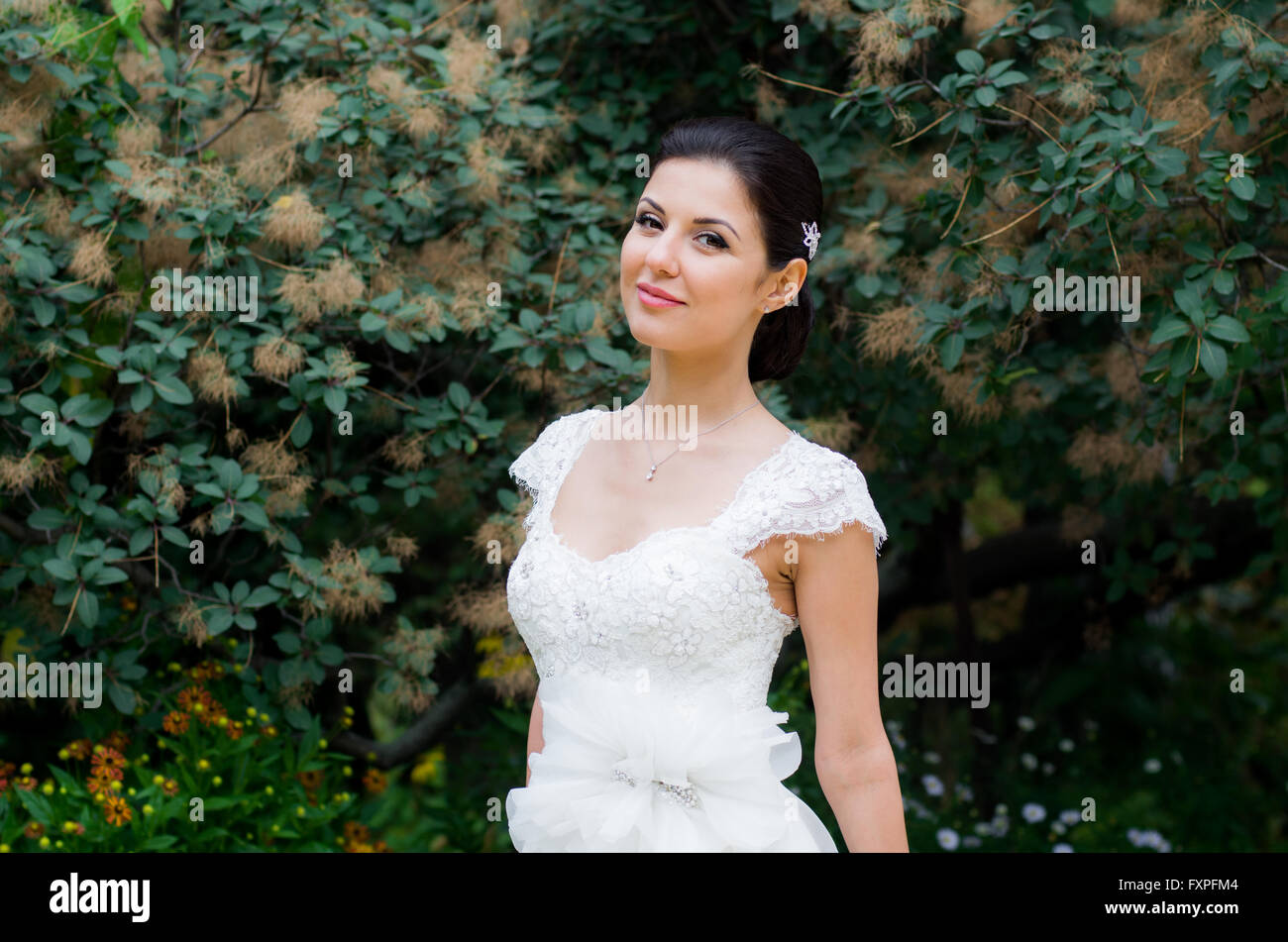 Portrait of the smiling bride in the garden Stock Photo - Alamy