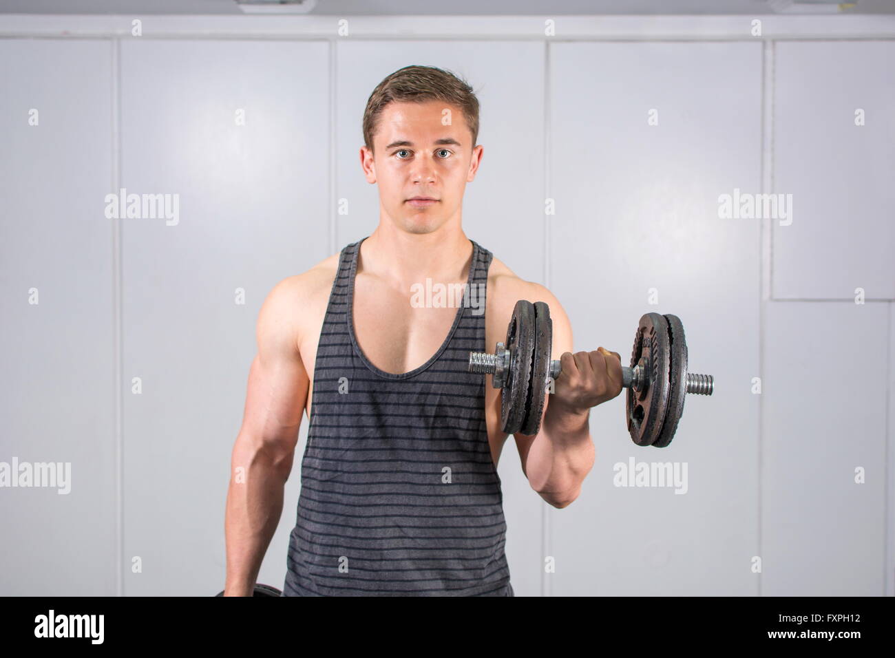 Man performing dumbbell curl at the gym. Biceps workout Stock Photo - Alamy