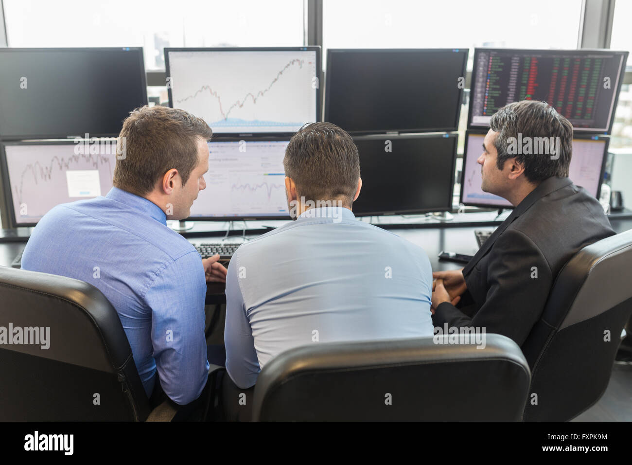 Business people looking at computer screens Stock Photo - Alamy
