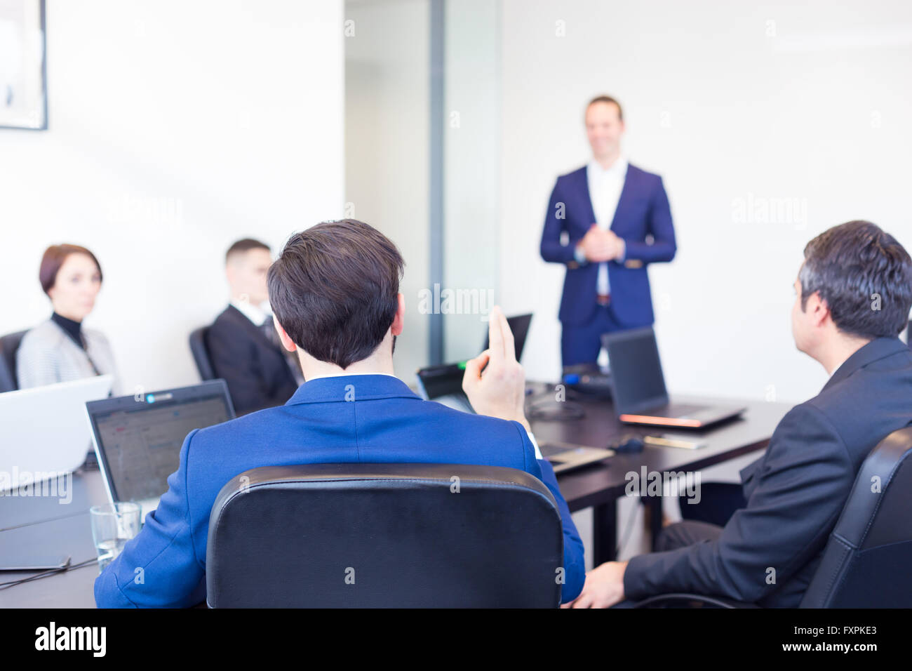 Colleague asking question to business team leader Stock Photo - Alamy