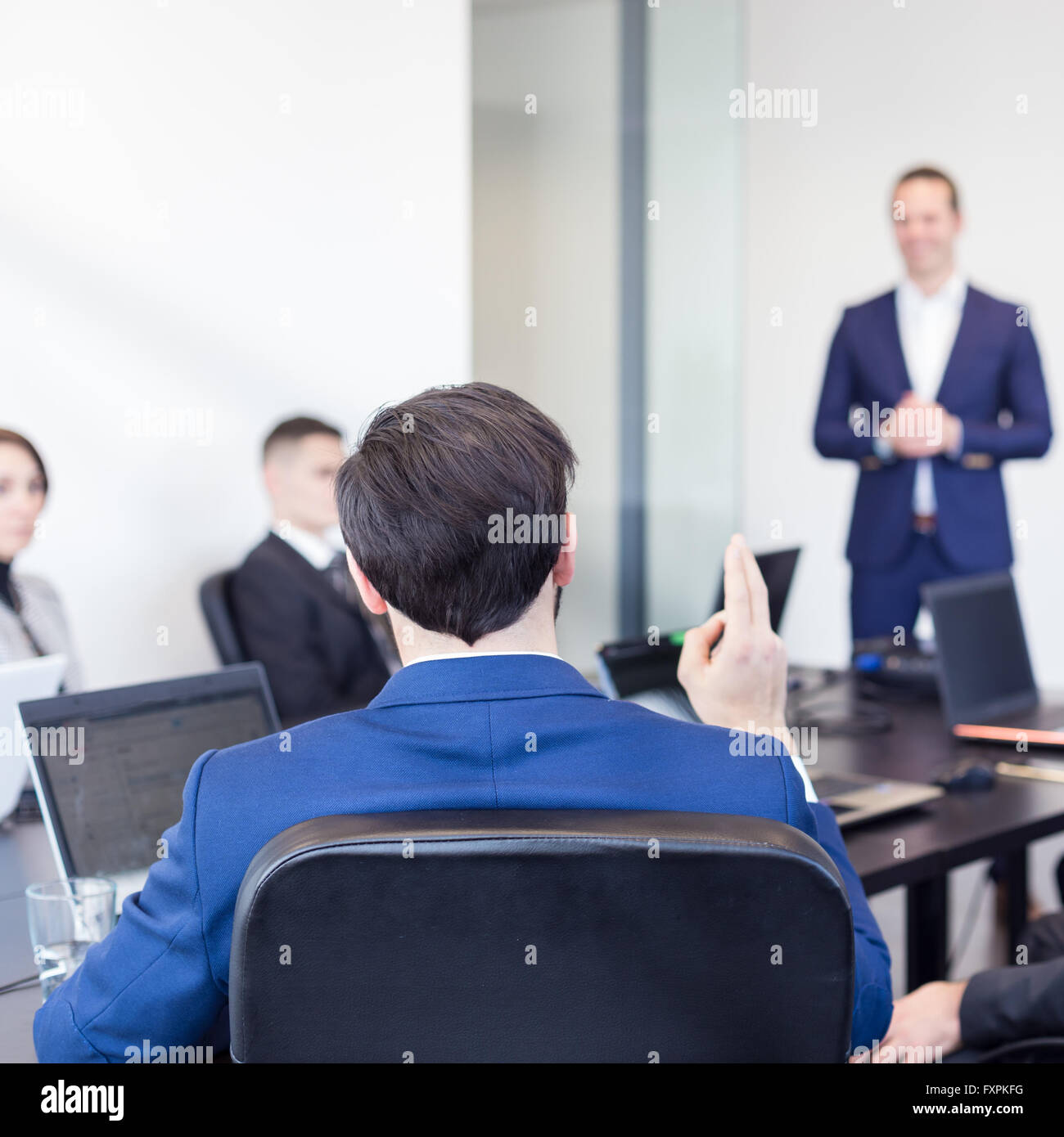 Colleague asking question to business team leader Stock Photo - Alamy