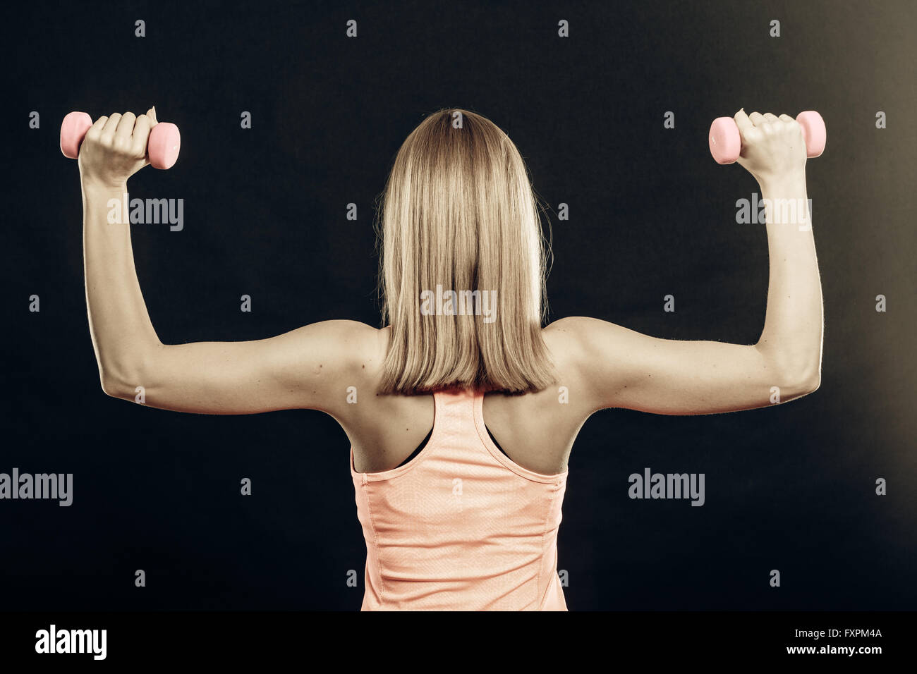 Rear view muscular woman flexing hi-res stock photography and images ...