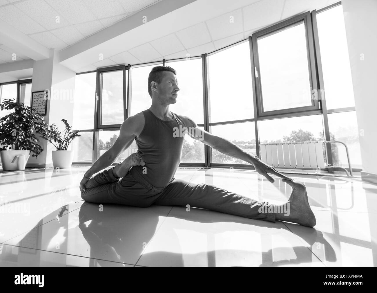 Yoga man training at the gym Stock Photo - Alamy