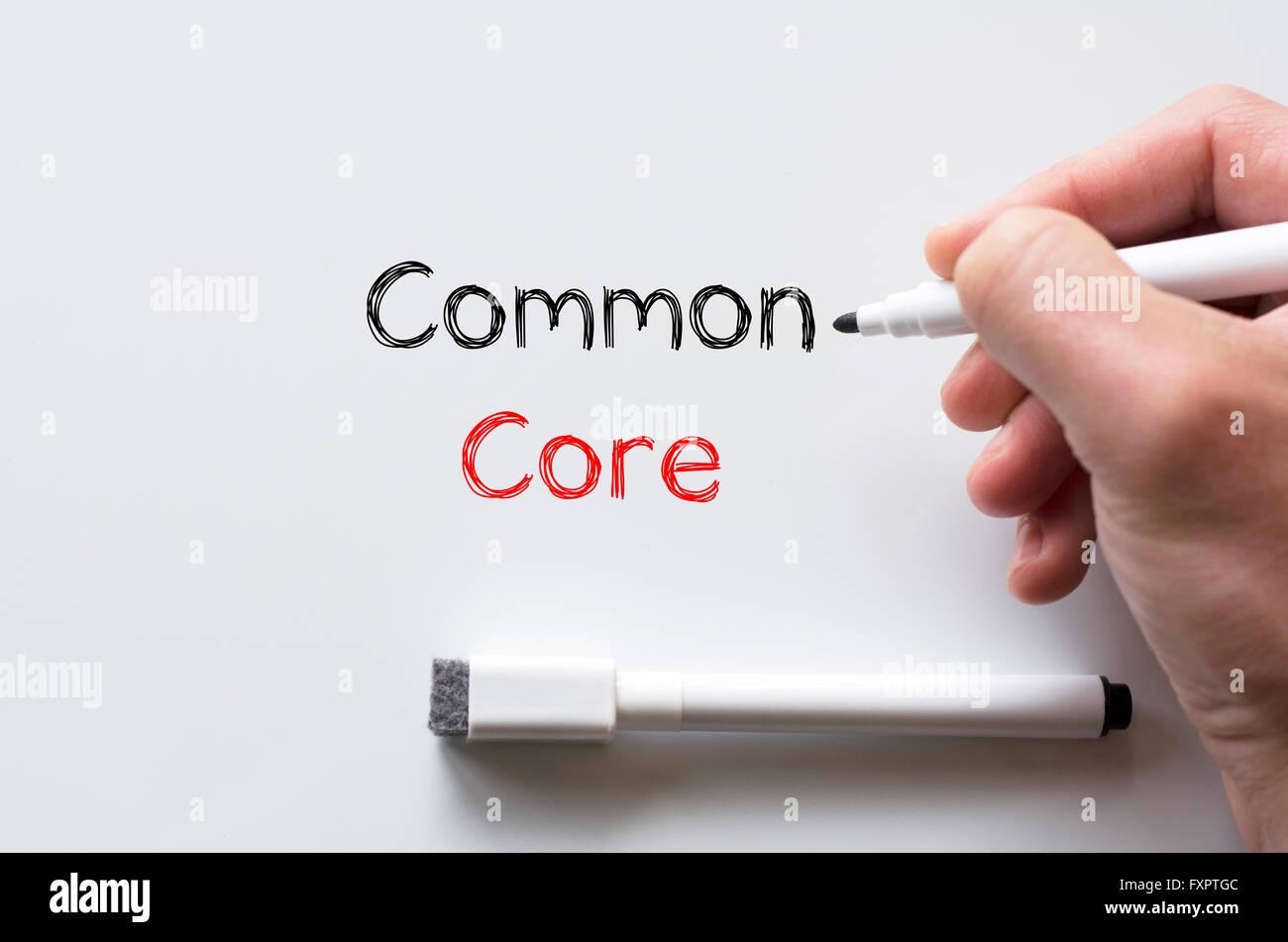 Human hand writing common core on whiteboard Stock Photo - Alamy