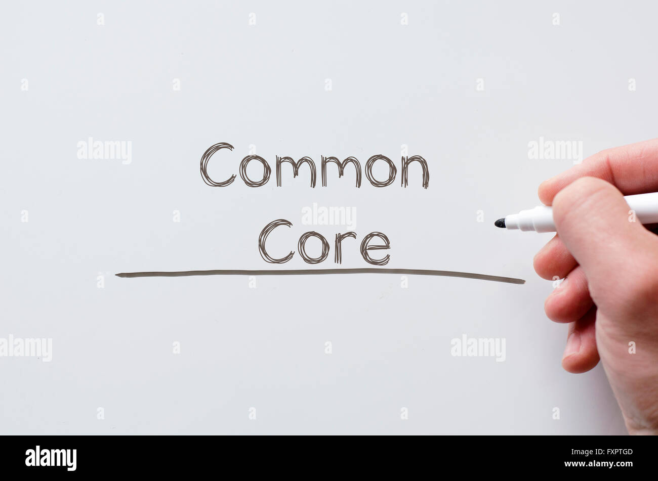 Human hand writing common core on whiteboard Stock Photo - Alamy