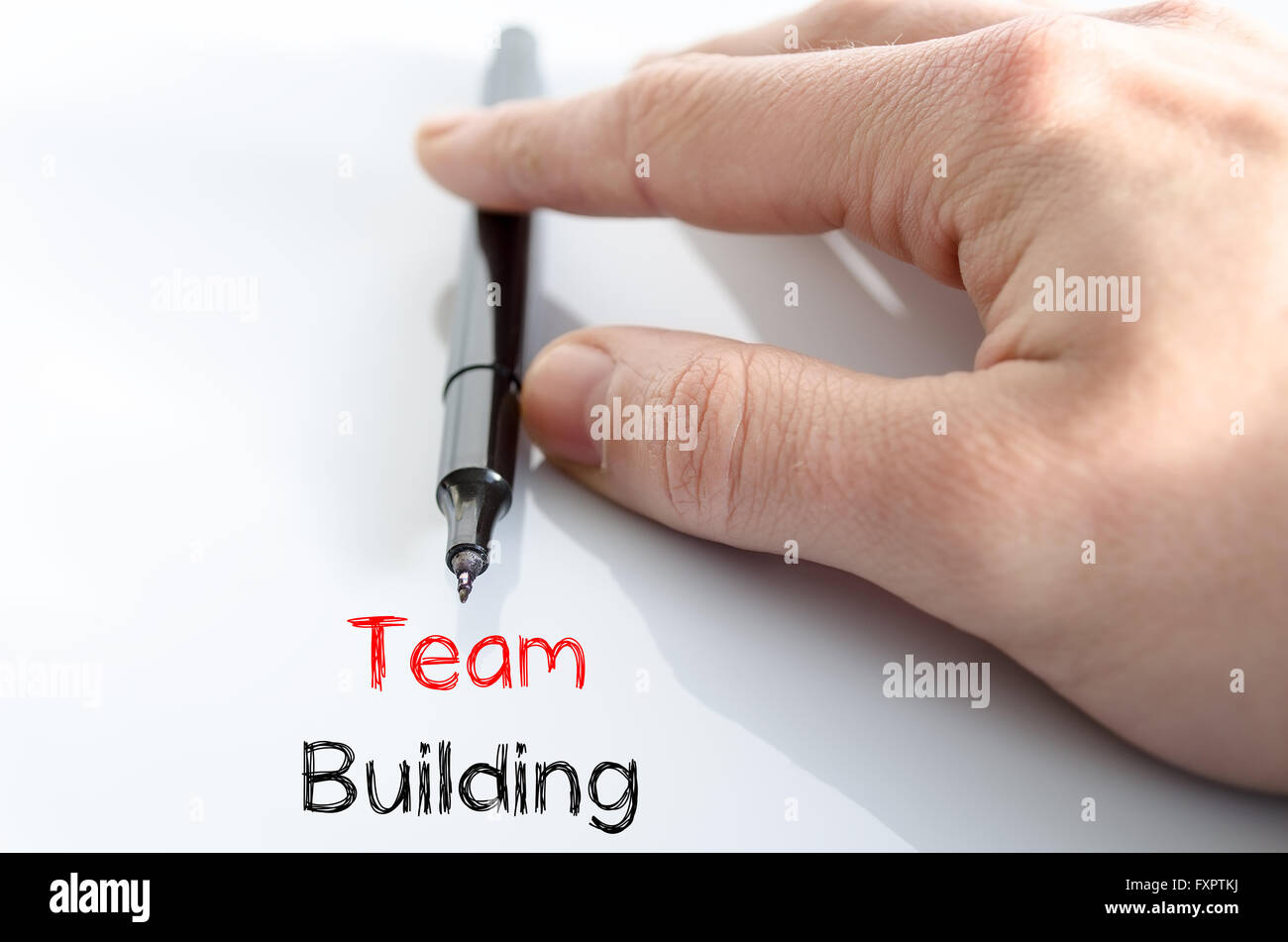 Team building note in business man hand Stock Photo - Alamy