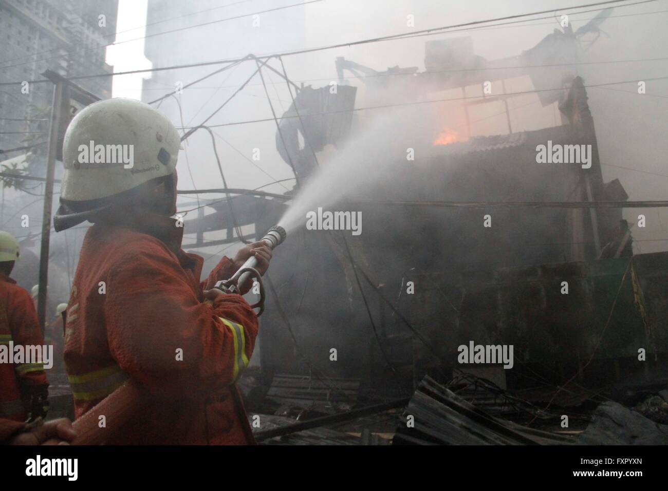 Jakarta, Indonesia. 17th Apr, 2016. Firefighter uses a fire hose to put ...