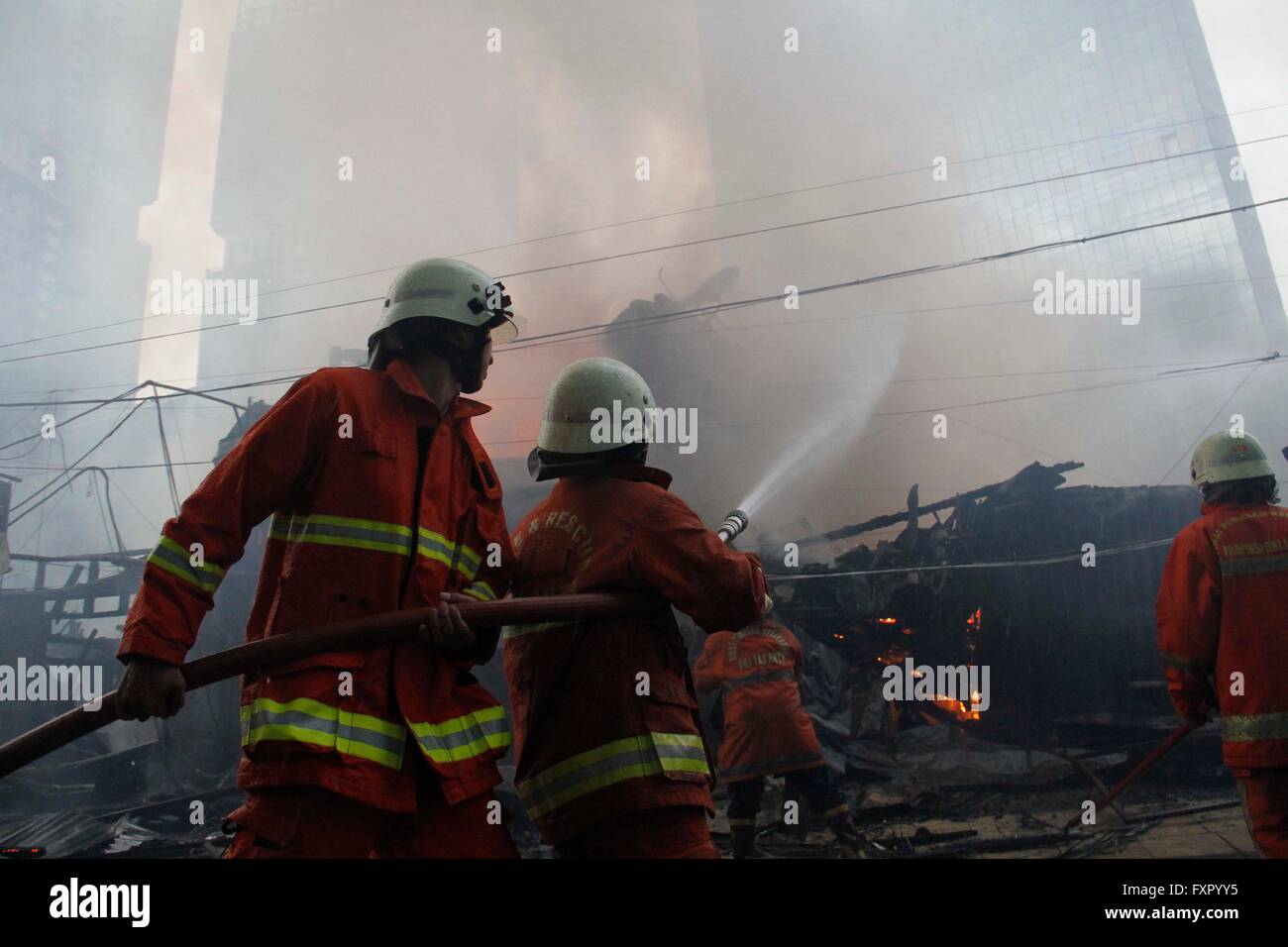 Jakarta, Indonesia. 17th Apr, 2016. Firefighter uses a fire hose to put ...