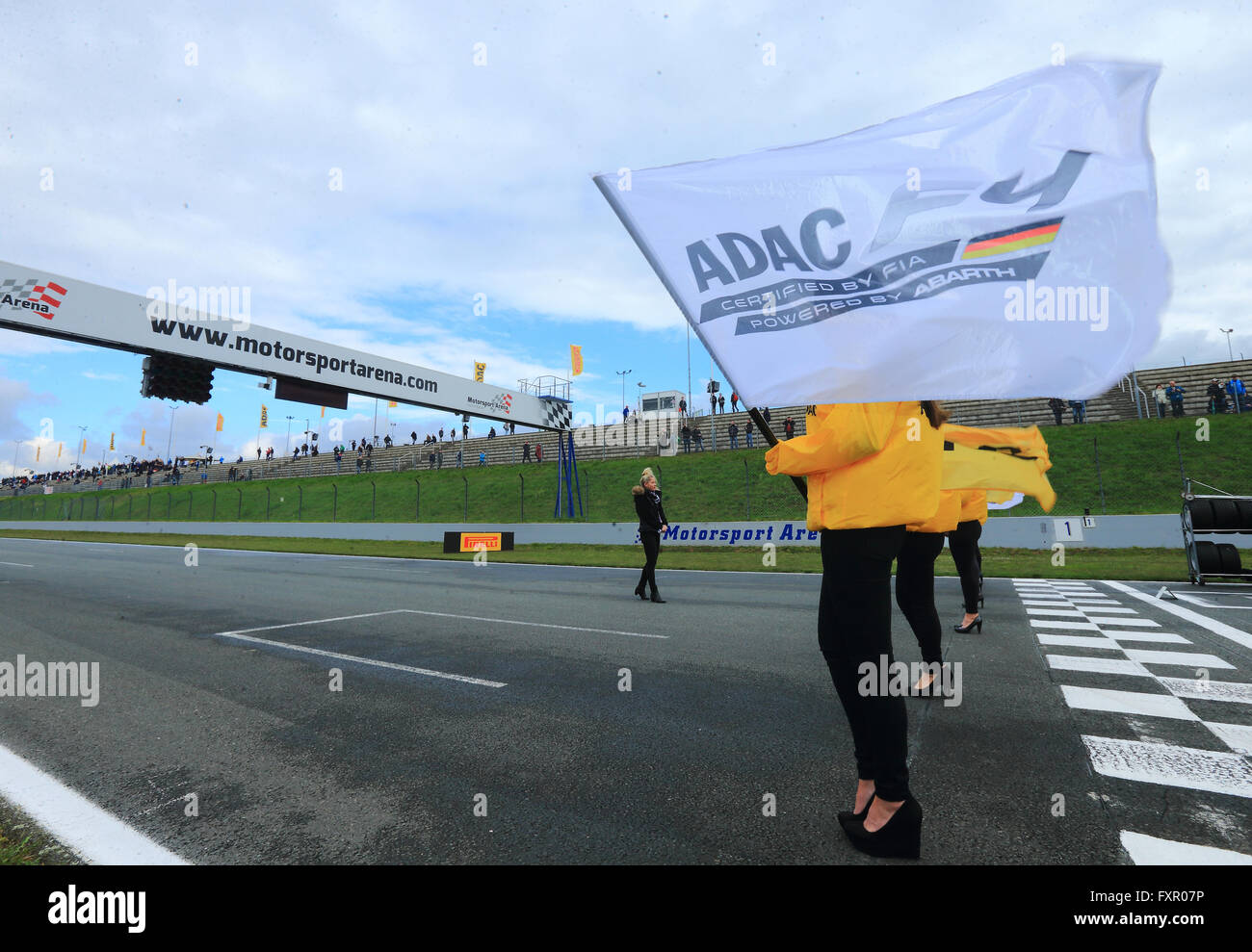 Grid girls carrying flags pictured on the race track at the ADAC ...