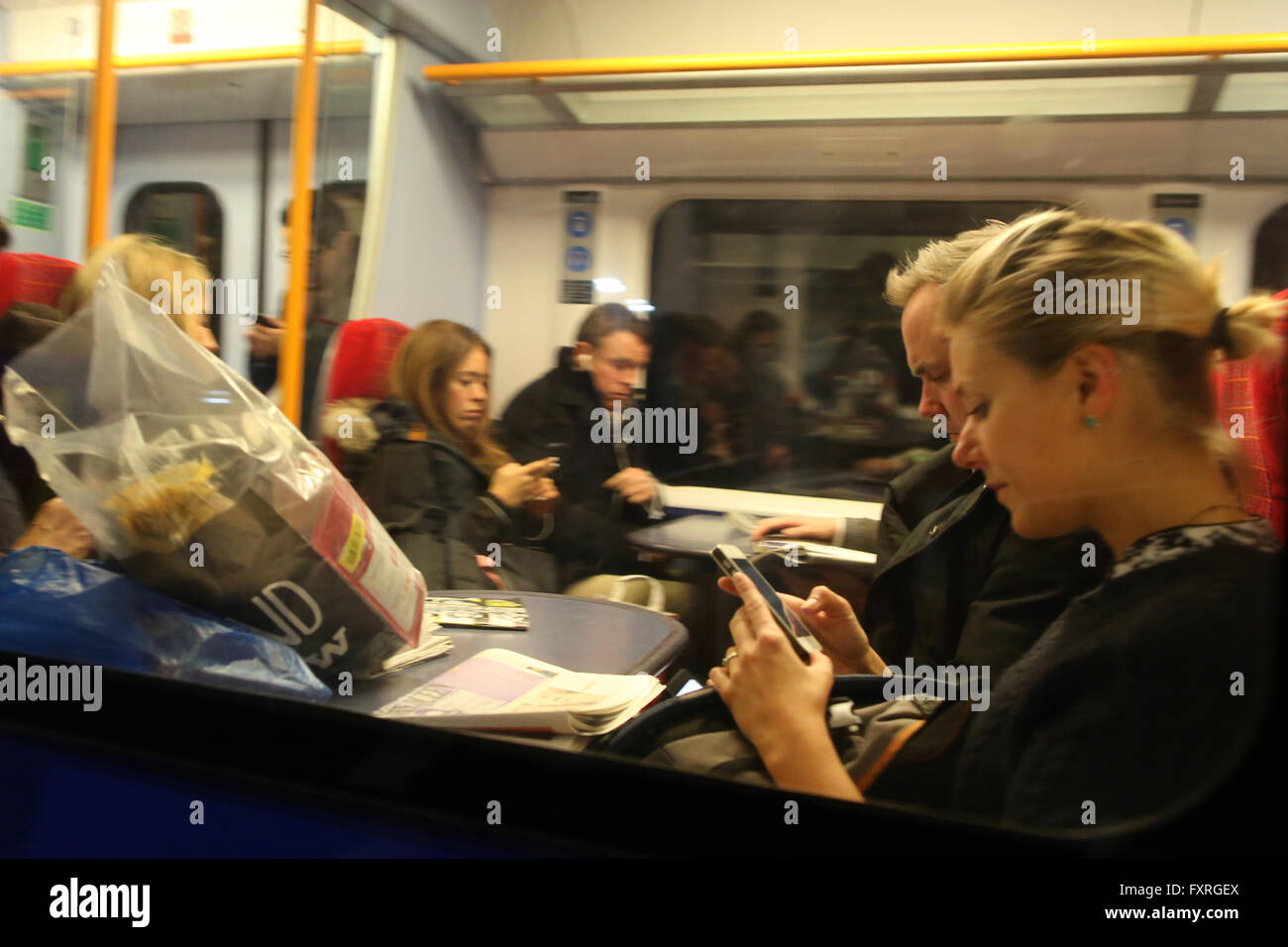 Commuters on the train, Waterloo station,London,UK Stock Photo - Alamy