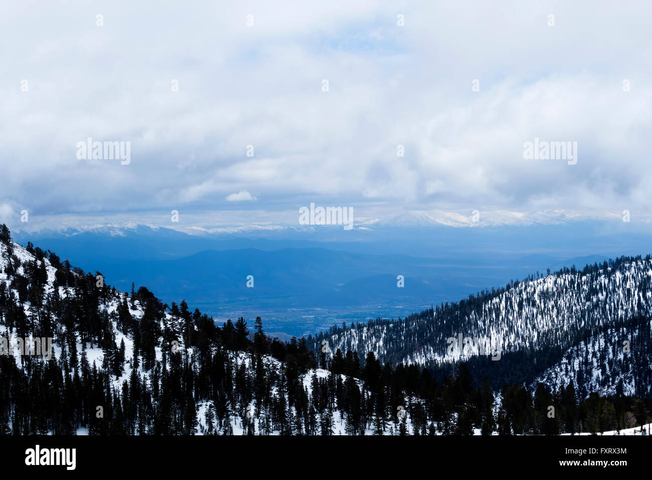 Near And Far Mountains With Snow Clouds Trees Stock Photo - Alamy