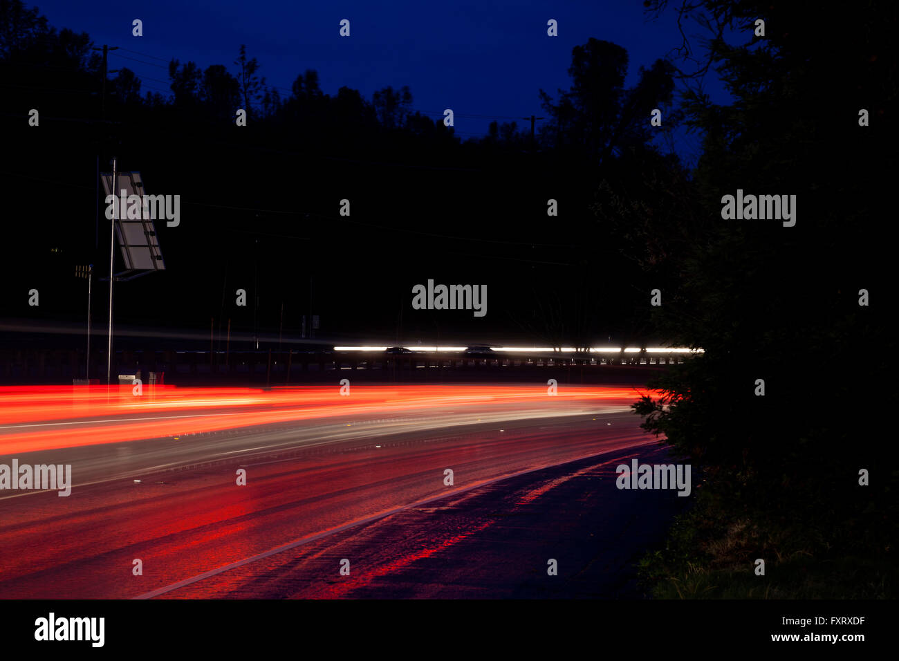 Curved Road Night Red Tail Light Trails Stock Photo - Alamy