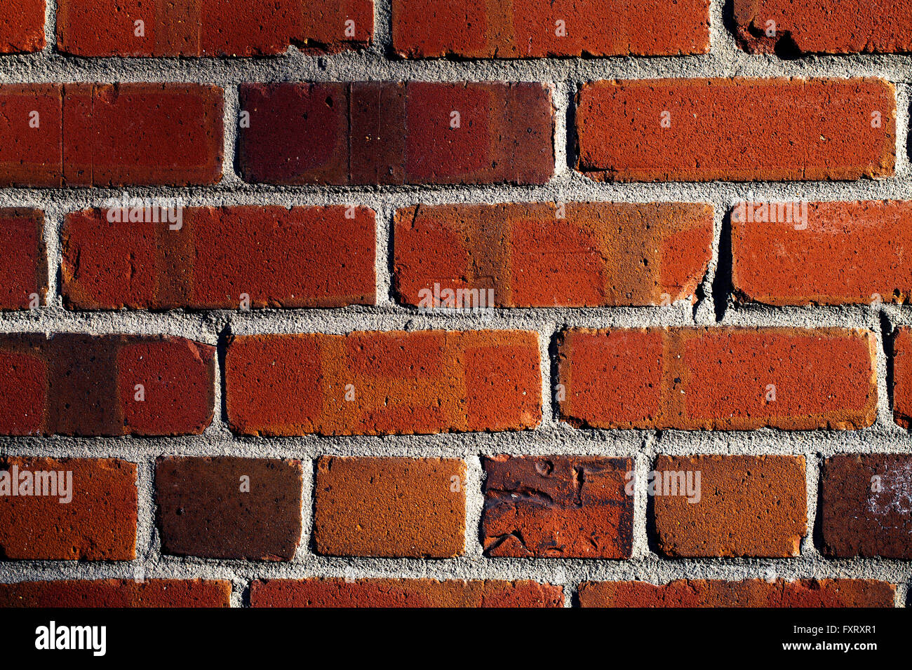 Side lighting on Red Brick Wall Showing Texture Stock Photo - Alamy