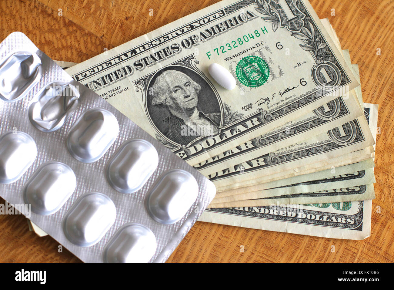 American dollars and pills together making a statement Stock Photo - Alamy