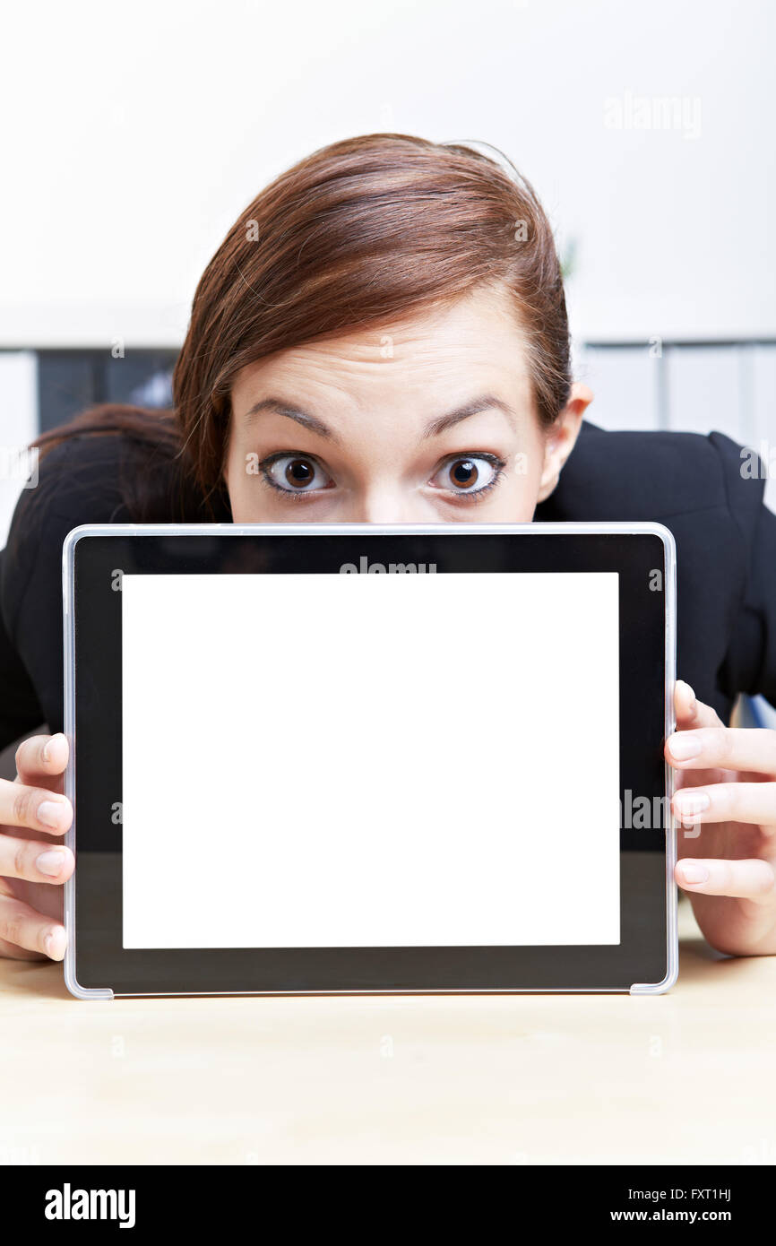 Scared business woman hiding behind tablet pc in her office Stock Photo ...