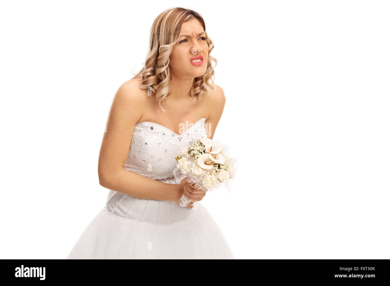 Studio shot of a young bride experiencing pain in her abdomen isolated ...