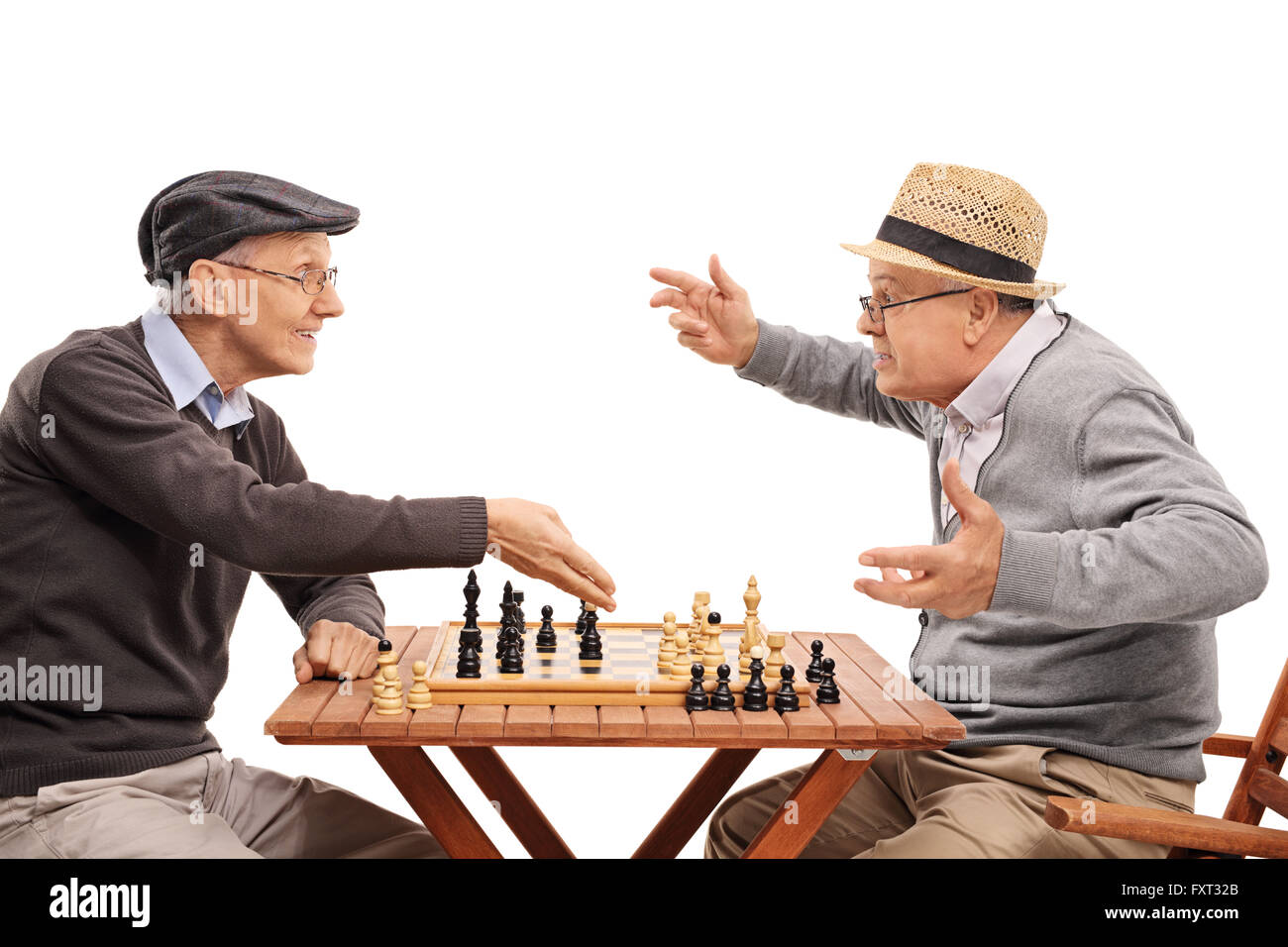 Two old people playing a game of chess isolated on white background ...