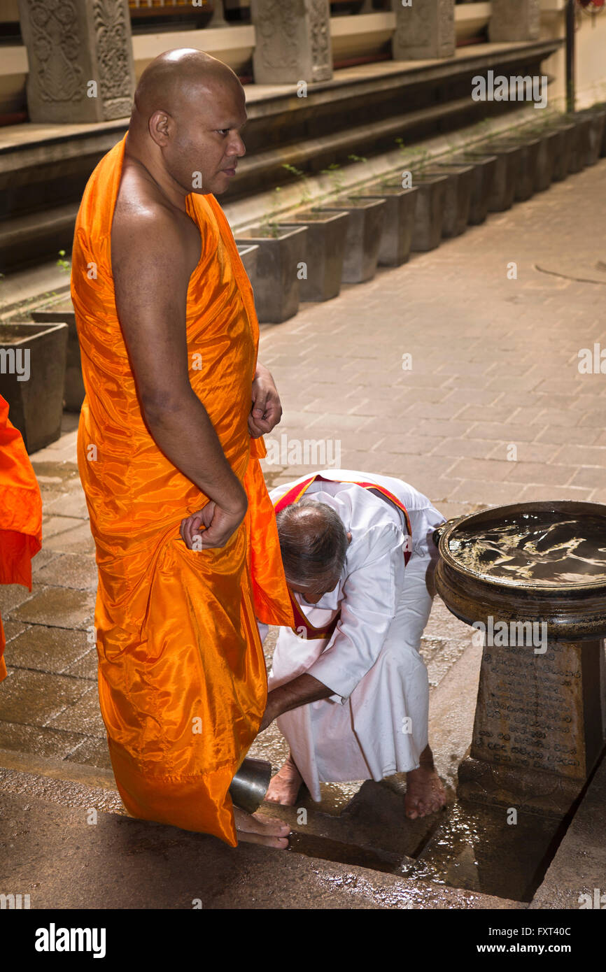 Sri Lanka, Kandy, Temple of the Tooth Relic, devotee cleaning feet of ...