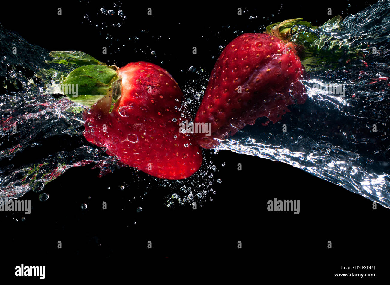 creative fresh strawberries impact water splash Stock Photo - Alamy