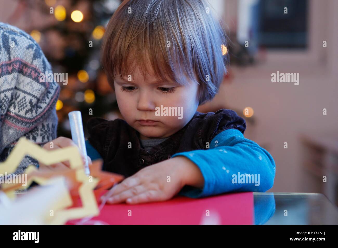 Girl looking down concentrating on writing Stock Photo - Alamy