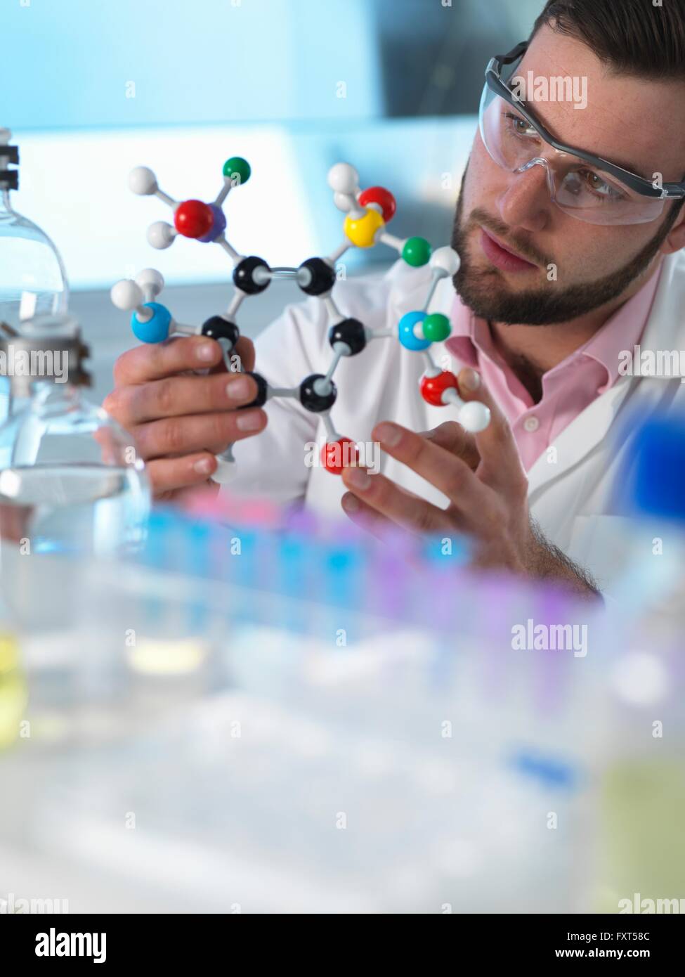 Scientist examining molecular model structure in laboratory Stock Photo ...